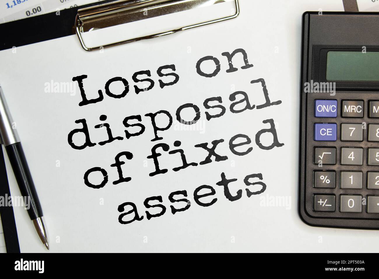 Loss on disposal of fixed assets label on notepad with laptop and ...