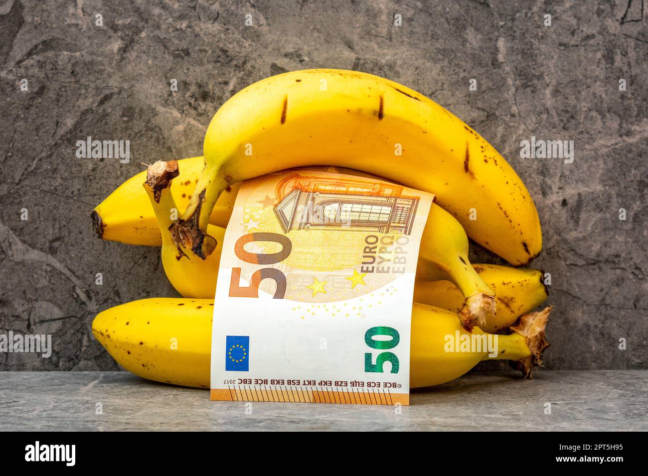 Pile of ripe bananas with a fifty euro banknote. Conceptual image Stock ...