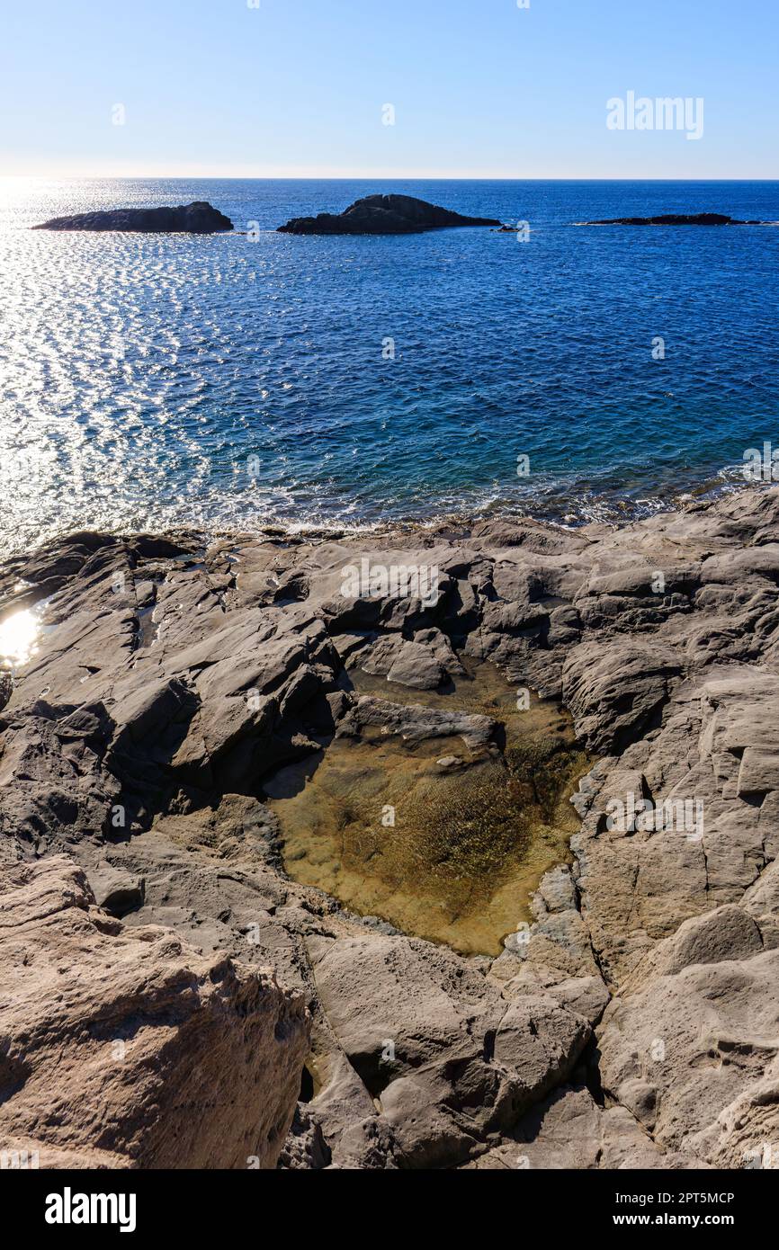 unusual rock formations of the volcanic cliff on Cala Sapone beach ...