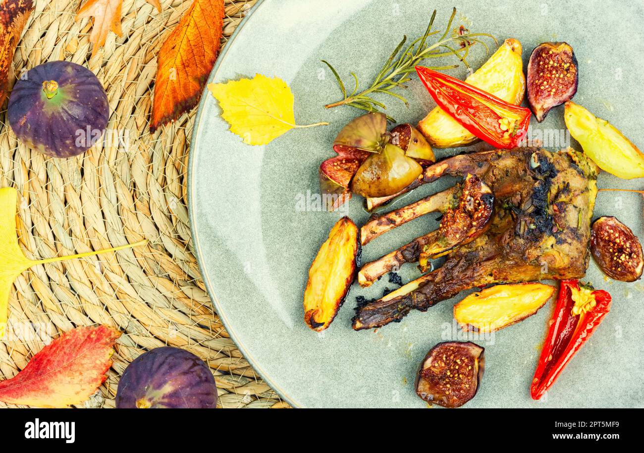 Lamb meat on the ribs, roasted with figs. Rack of lamb Stock Photo - Alamy