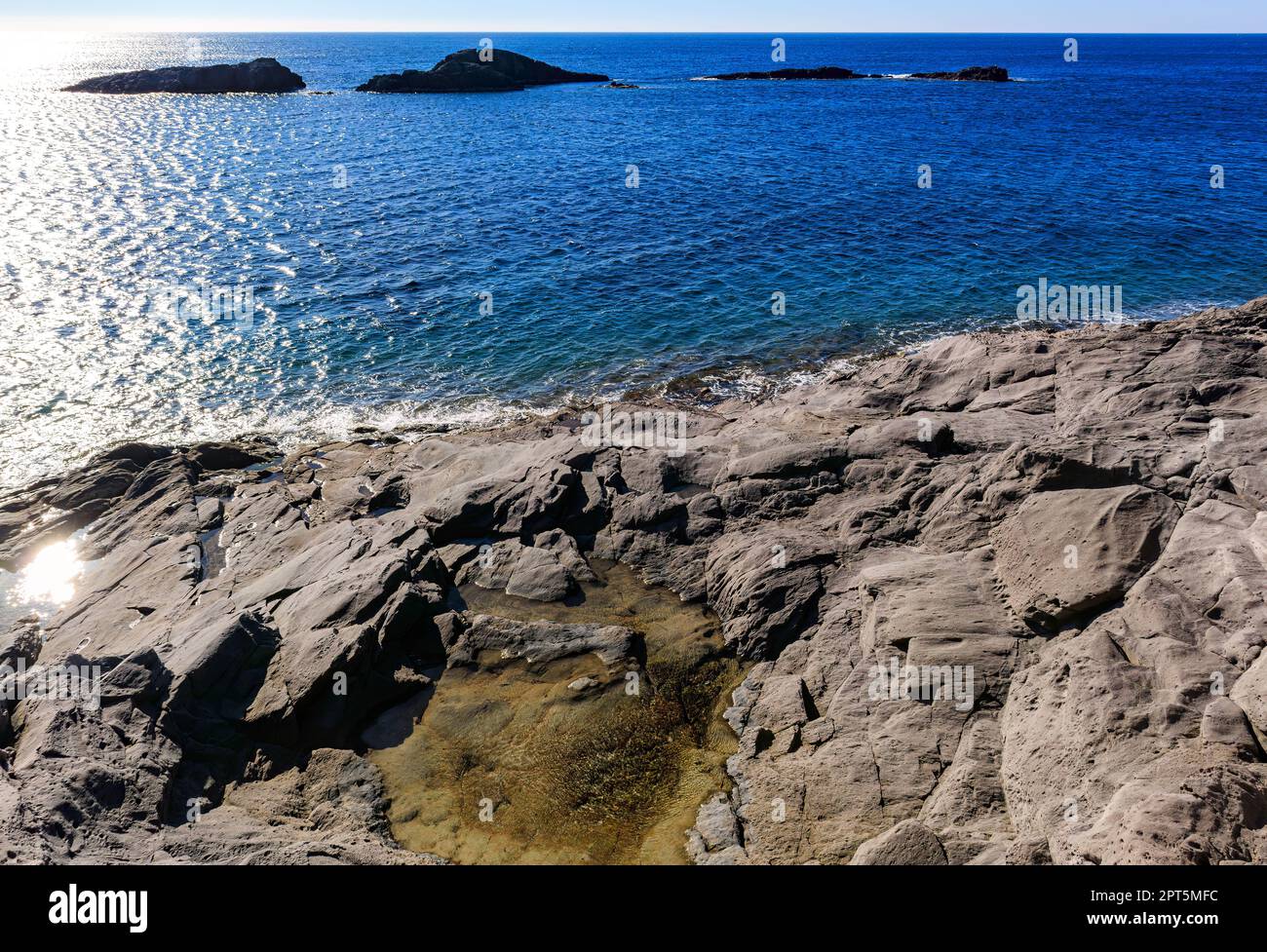 unusual rock formations of the volcanic cliff on Cala Sapone beach ...