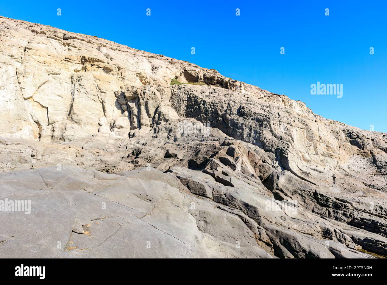 unusual rock formations of the volcanic cliff on Cala Sapone beach ...