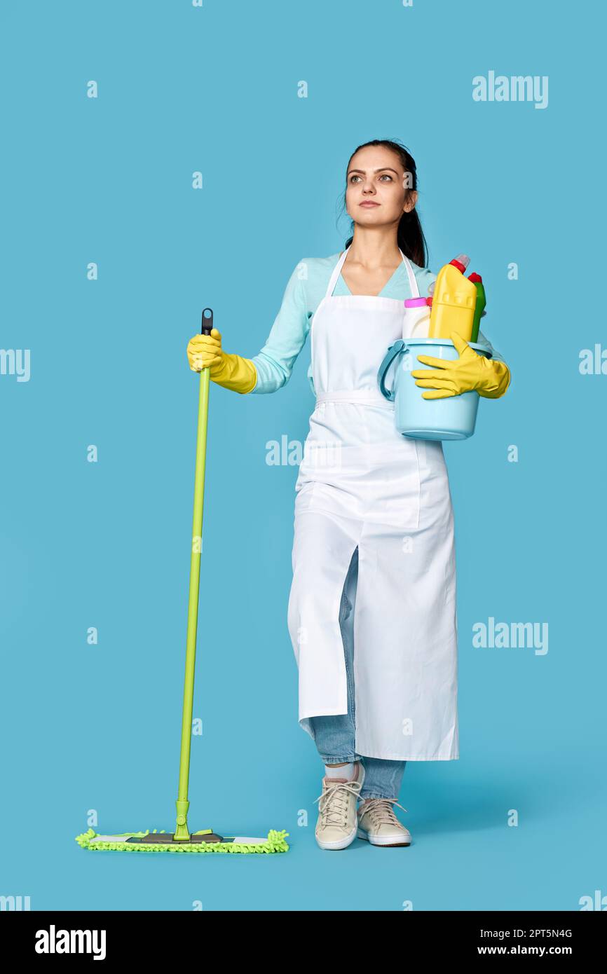 pretty woman in rubber gloves and cleaner apron with cleaning supplies ...