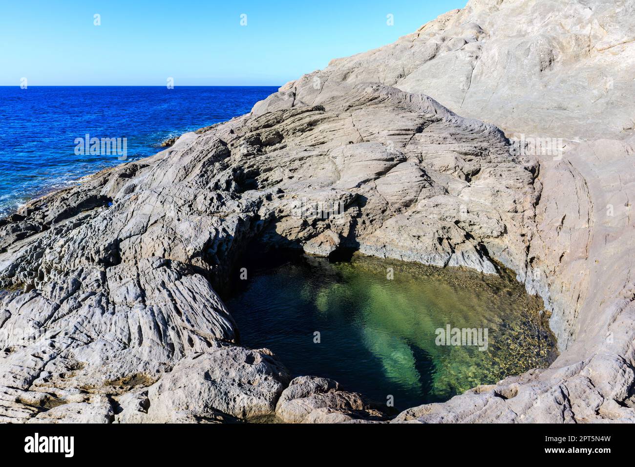 unusual rock formations of the volcanic cliff on Cala Sapone beach ...