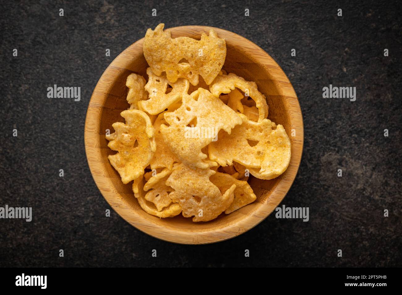 Halloween crispy bat shaped chips in the bowl. Top view Stock Photo - Alamy