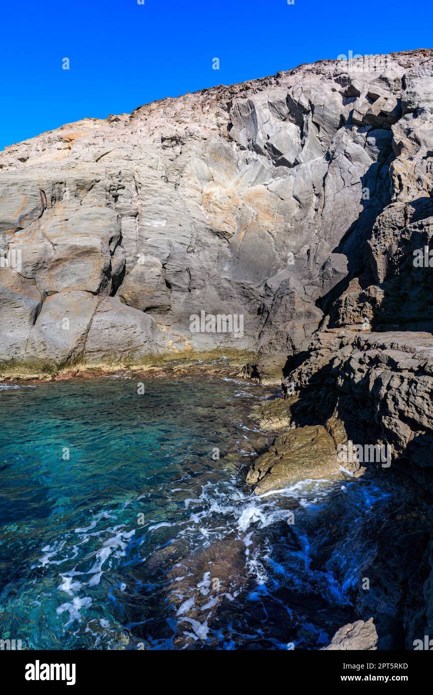 unusual rock formations of the volcanic cliff on Cala Sapone beach ...
