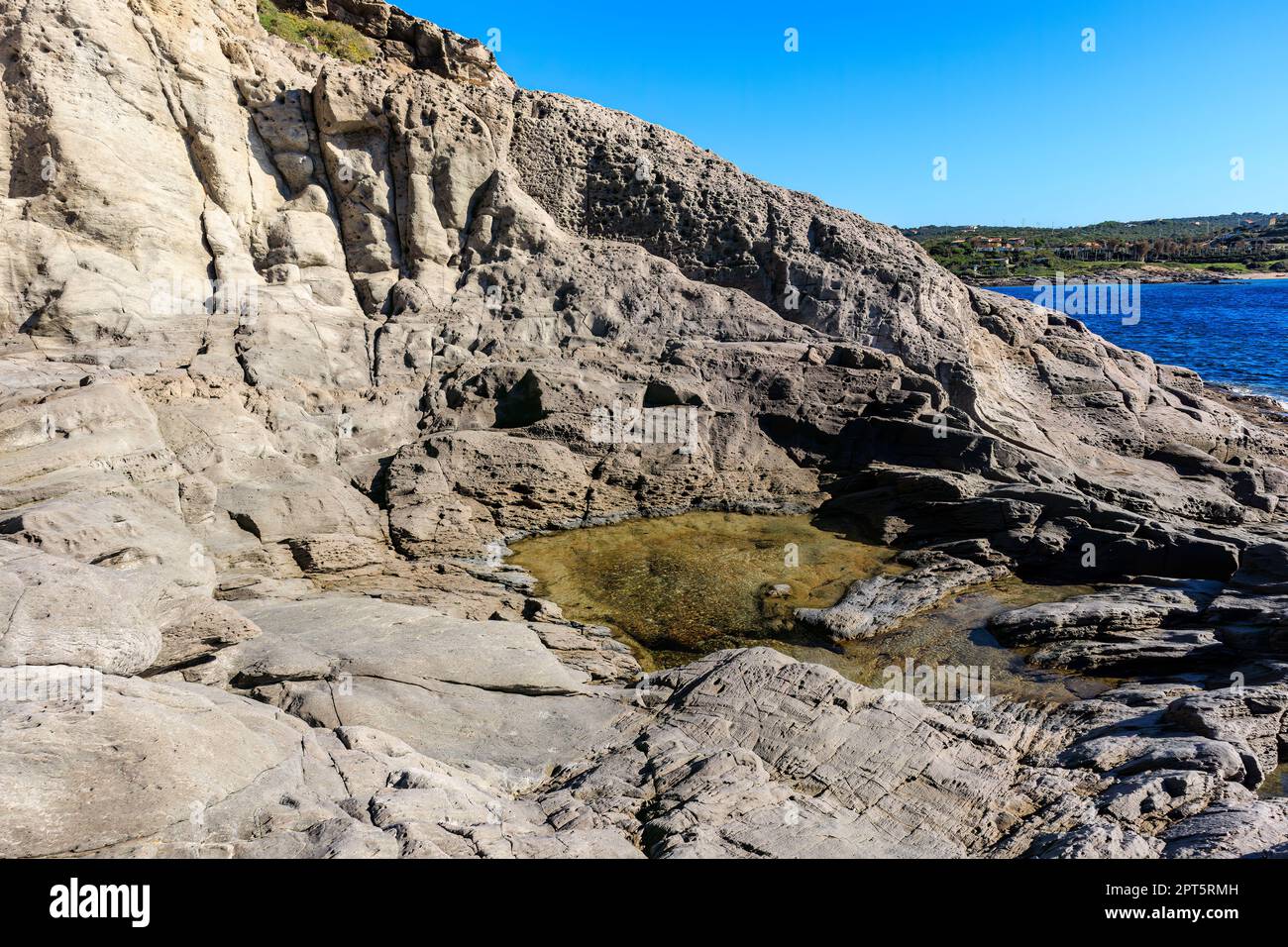 unusual rock formations of the volcanic cliff on Cala Sapone beach ...