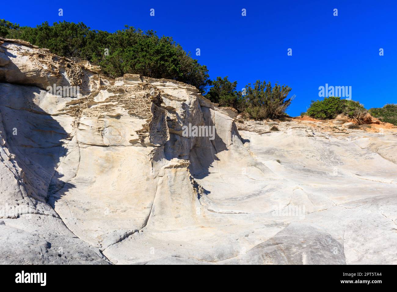 unusual rock formations of the volcanic cliff on Cala Sapone beach ...