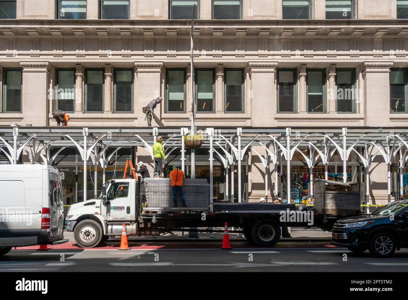 Workers construct scaffolding in the Chelsea neighborhood in New York ...