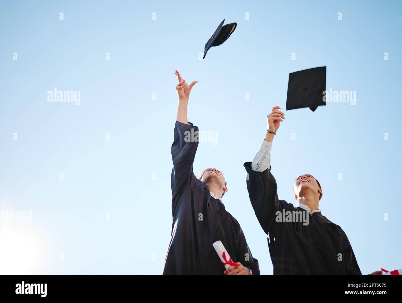 Blue Graduation Caps In The Air