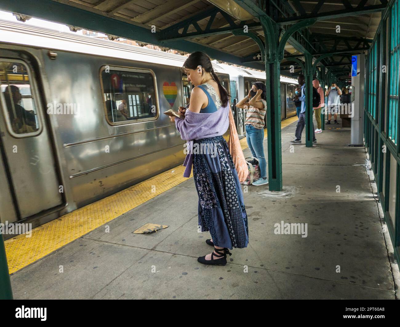 Passengers on the 125th Street station as a Number 1 train arrives, on ...