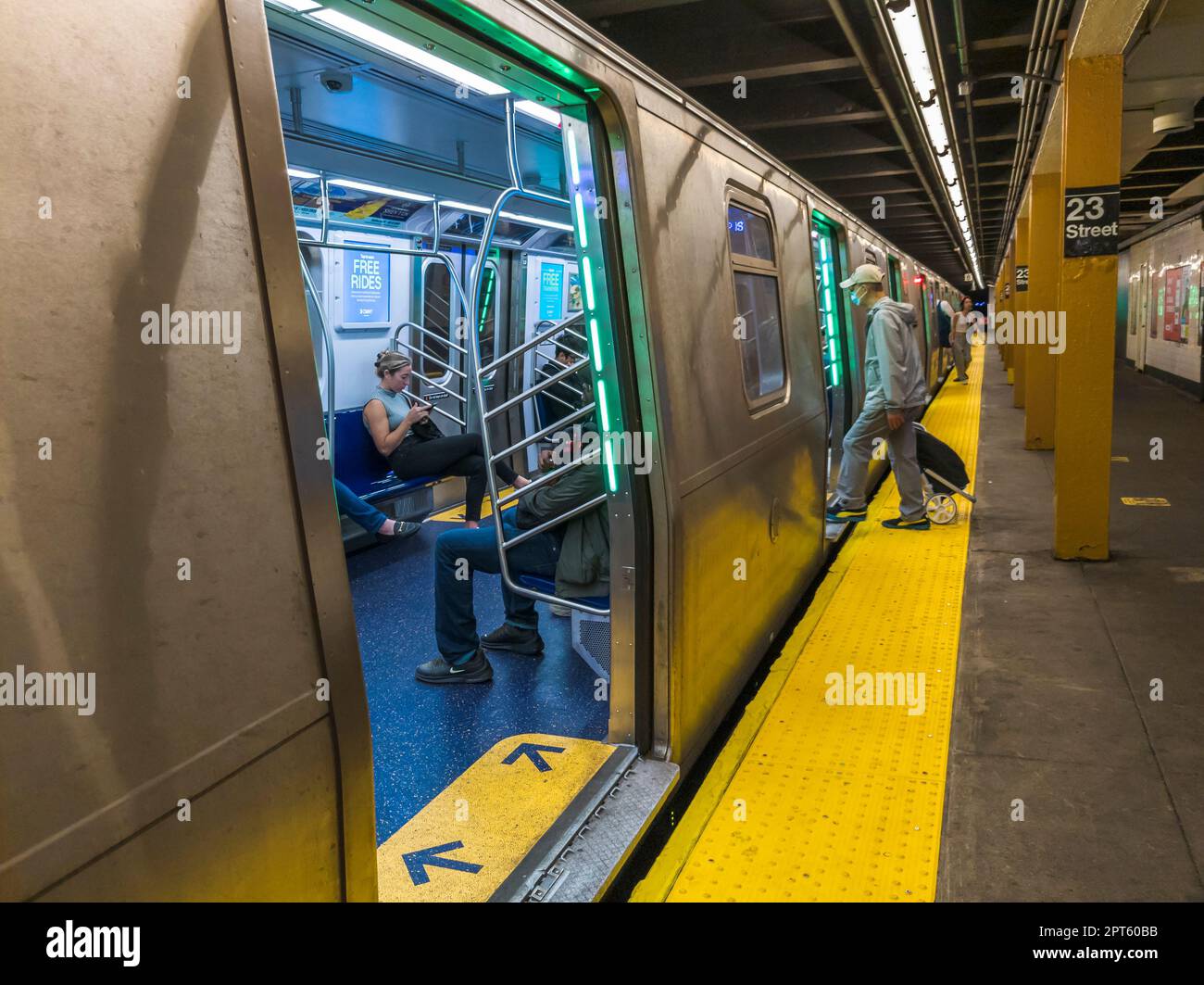 Travelers on the A train in the subway in New York enjoy the spanking ...