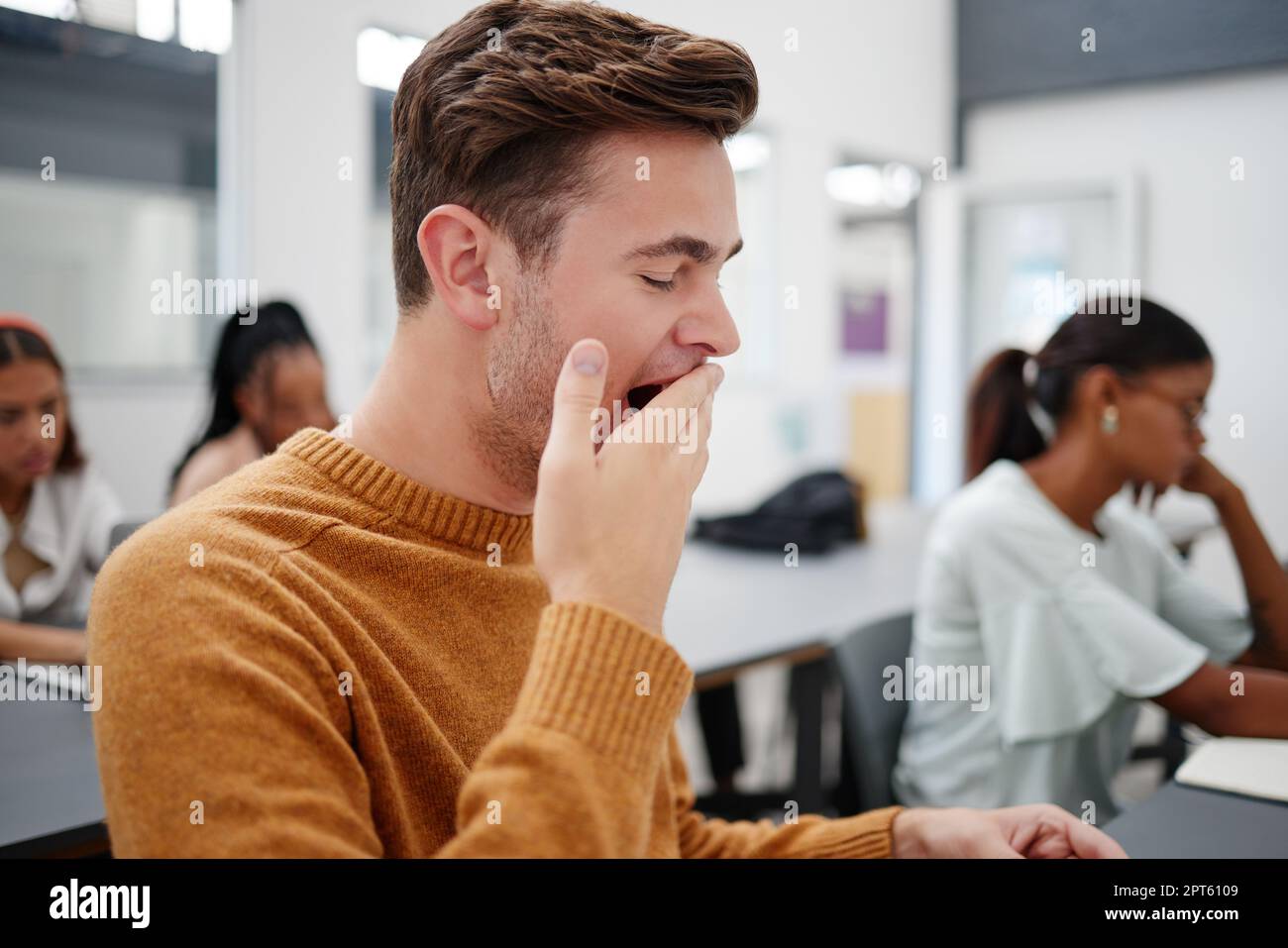 Burnout, tired student or yawning man sleepy in school, college or ...
