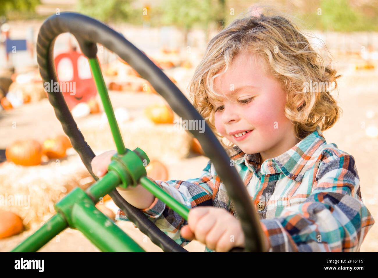 Little Boy Having Fun In A Tractor in a Rustic Ranch Setting at the ...