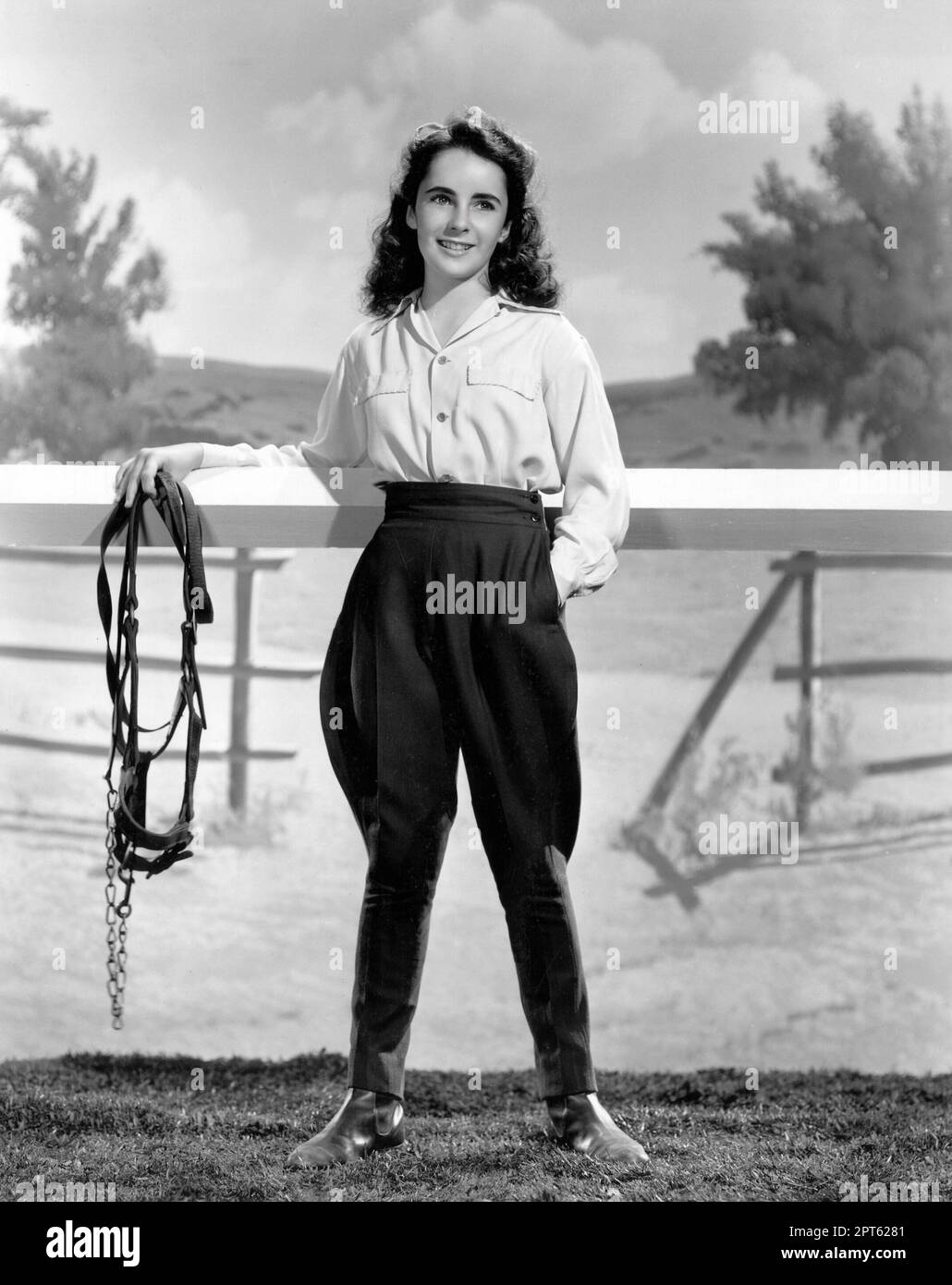 A young (12 y) smiling Elizabeth Taylor wearing riding clothes for the ...
