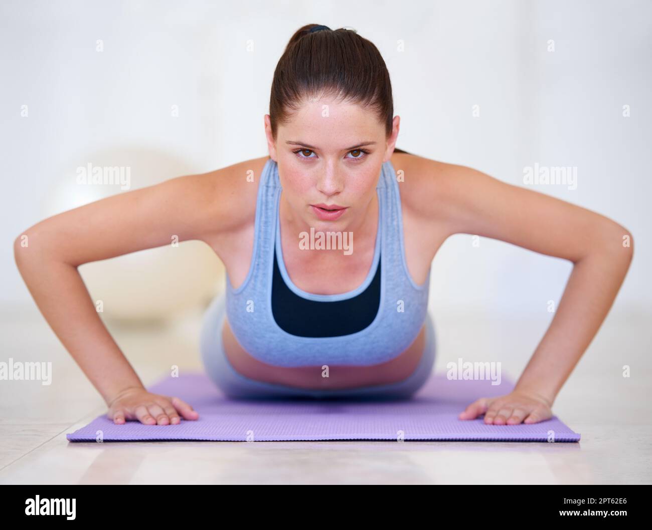 Focusing on the upper body. Portrait of a beautiful young woman doing ...