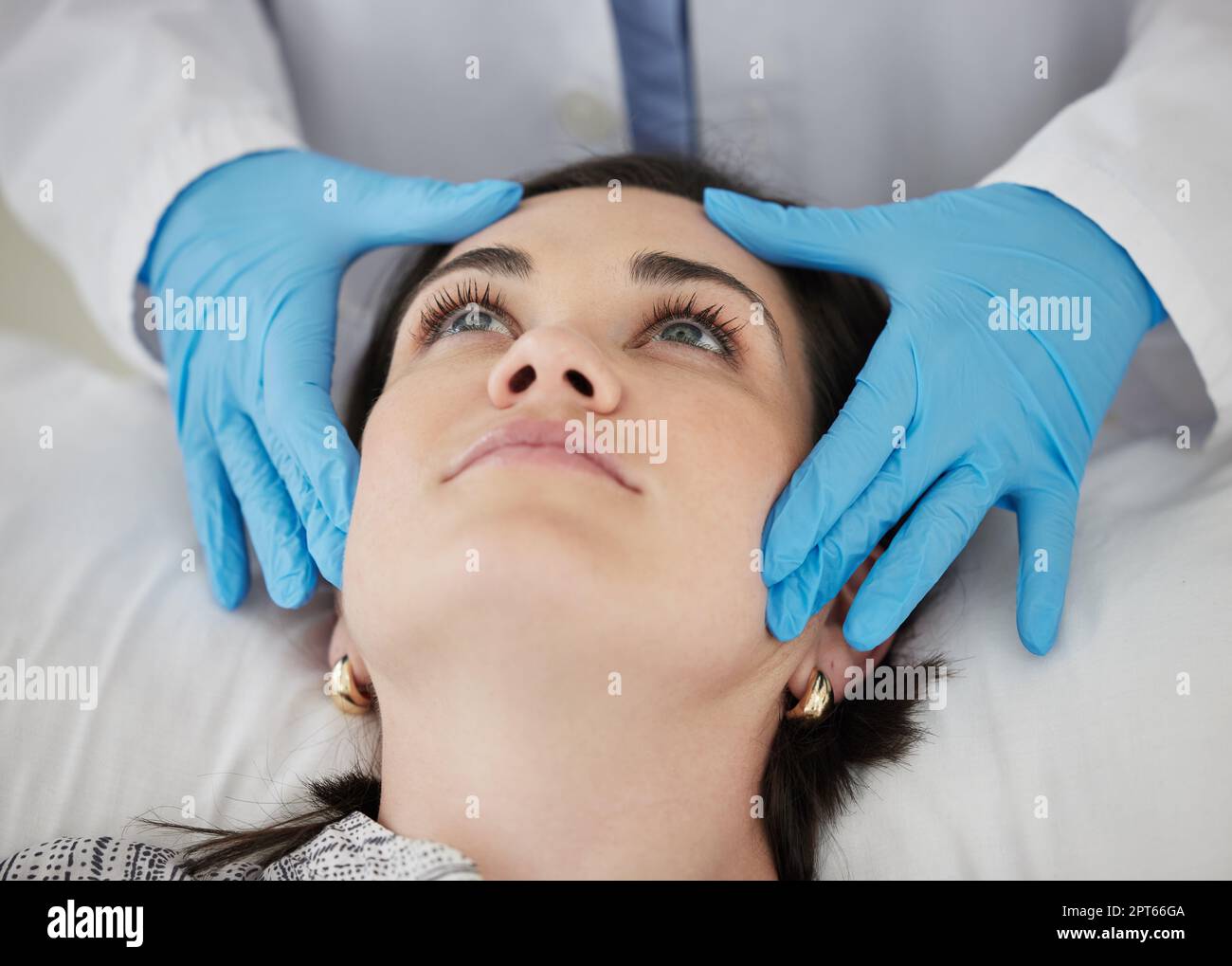 Your face is perfect for it. a doctor analysing a patients face before ...