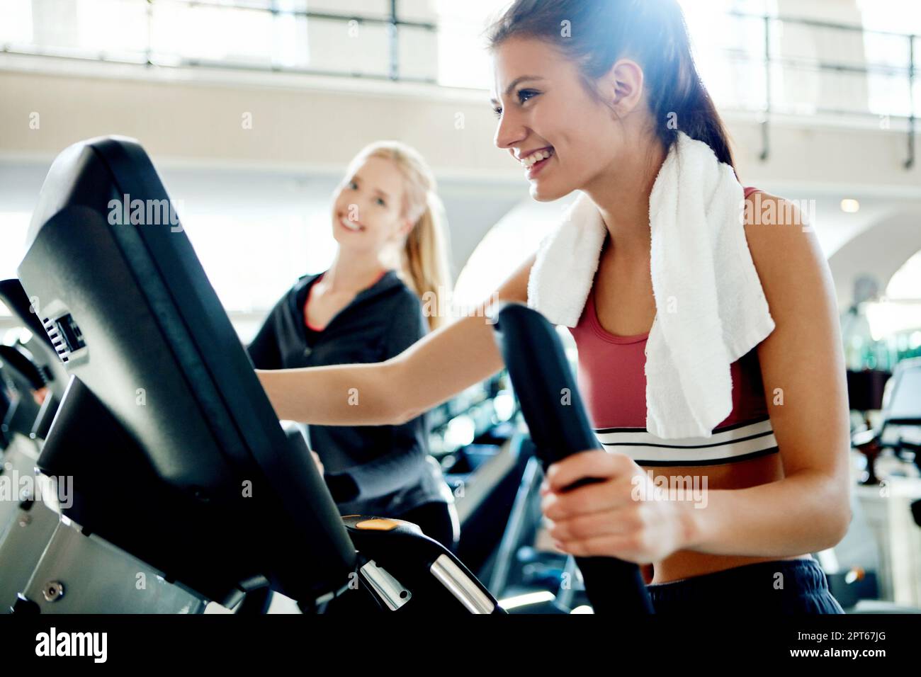 Faster. attractive young women working out on treadmills at the gym ...