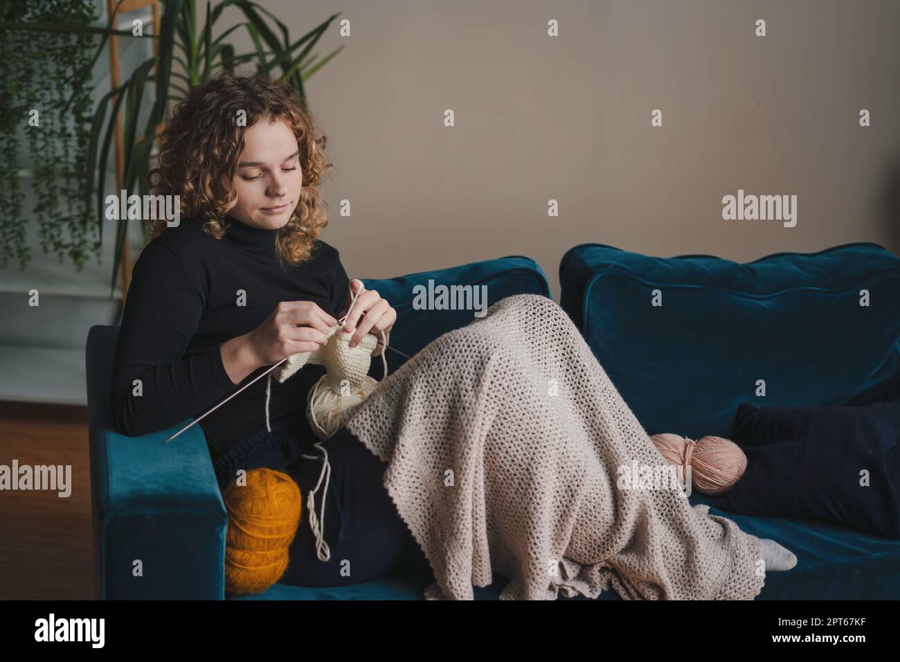 Young creative woman enjoying hobby working use ribbon yarn, relaxing ...