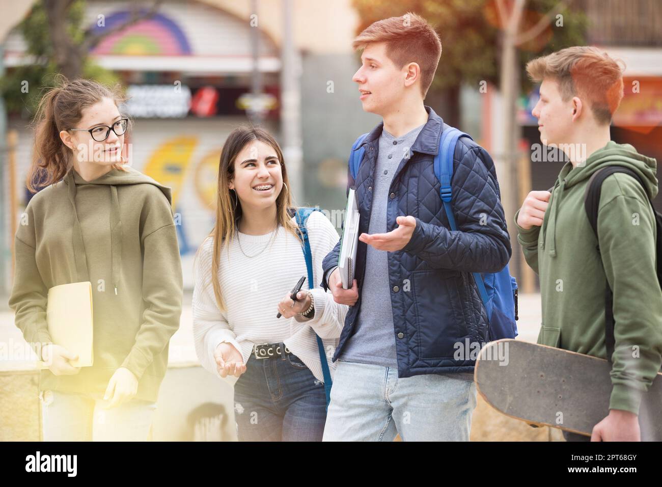 Carefree teen students walking outside school Stock Photo - Alamy