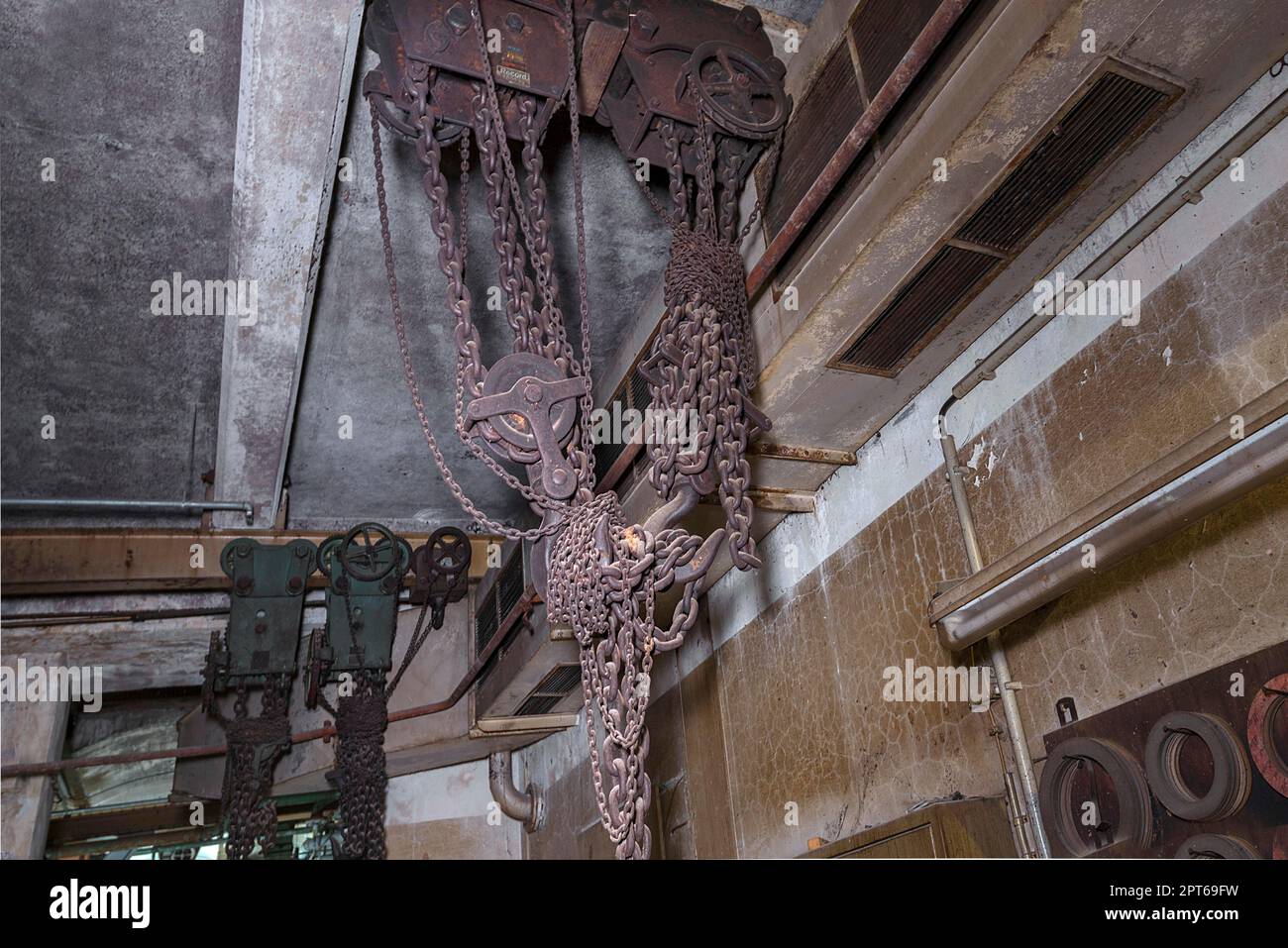 Chains from a pulley block of a former paper factory, Lost Place, Baden ...