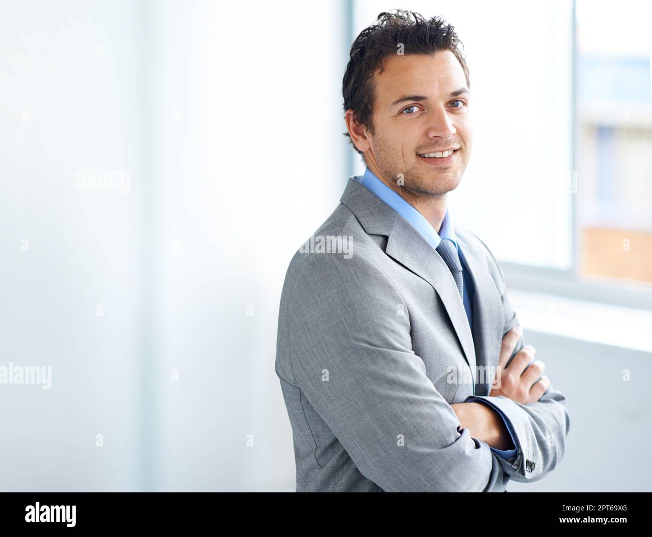Looking to the future. Portrait of a handsome young executive standing ...