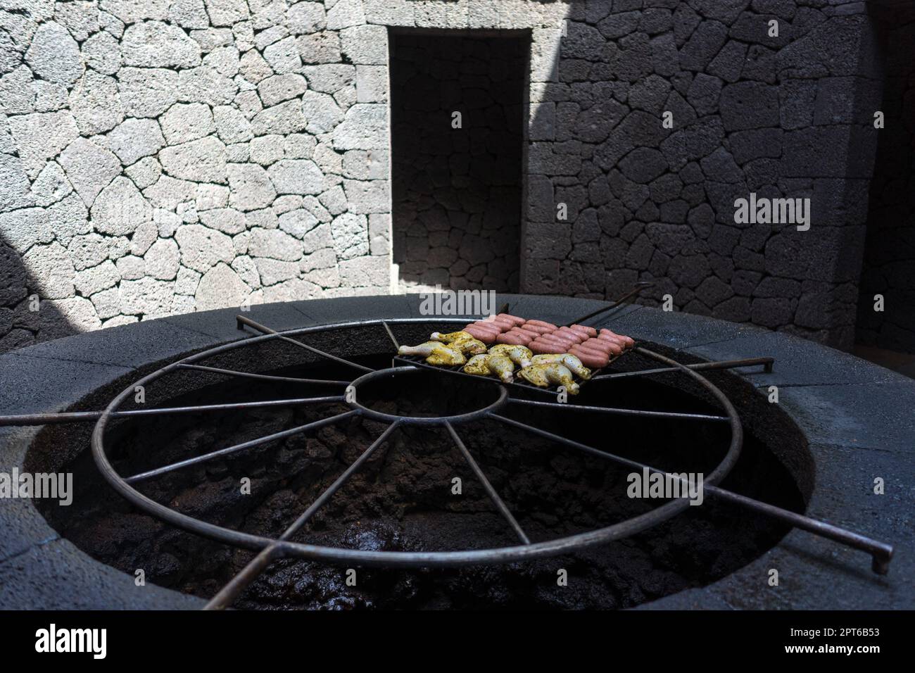 Chicken and sausages barbecued on volcanic heat, Timanfaya National ...