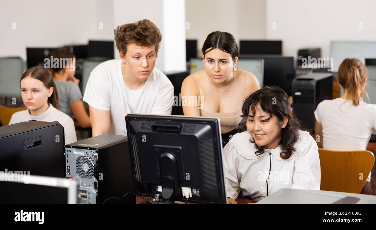 Teenagers using computer during computer science lesson Stock Photo - Alamy