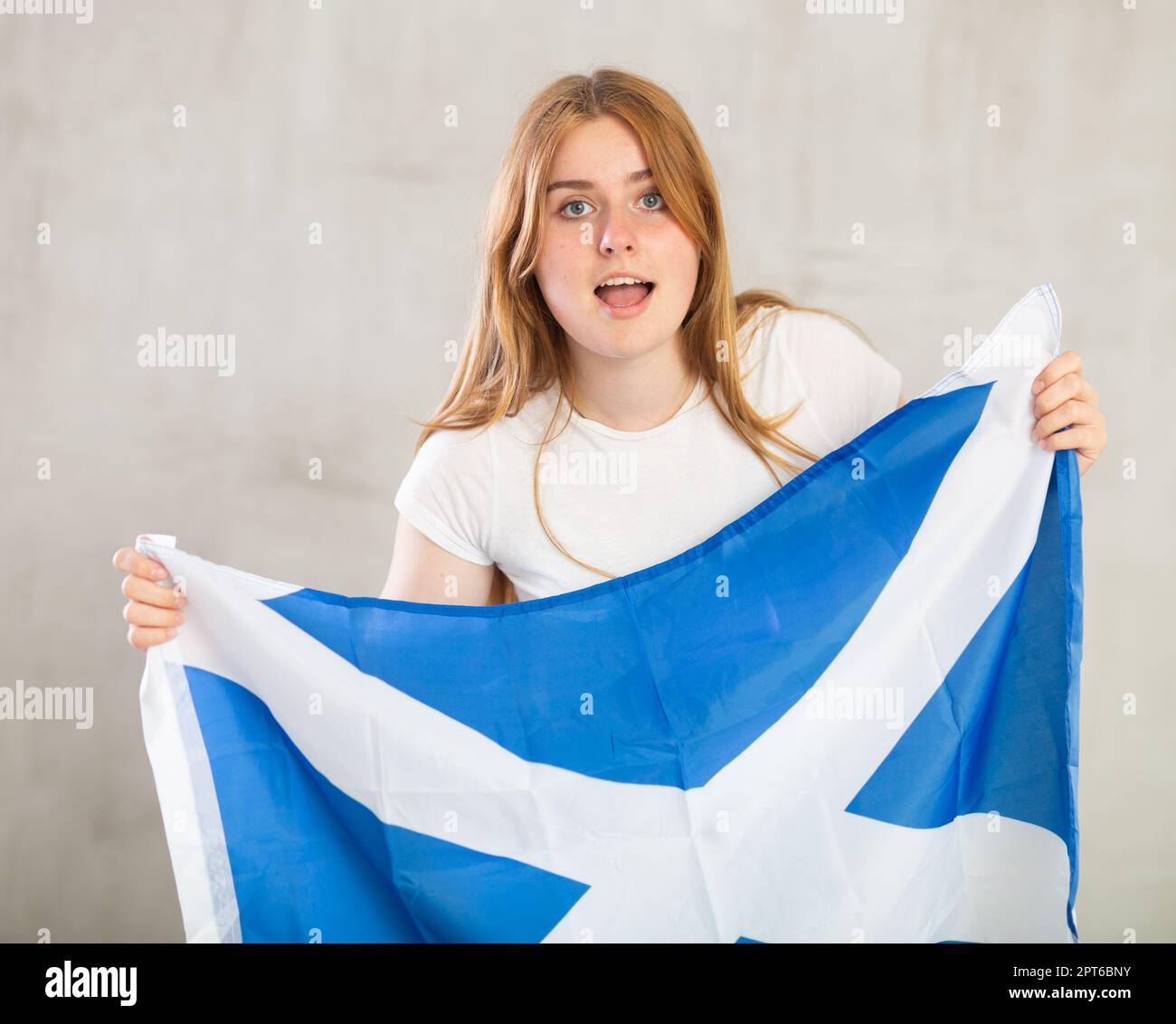 Excited young girl with Scotland flag rooting for your favorite team ...