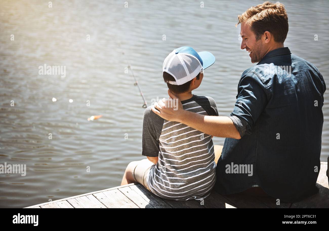Strengthening their bond over a weekend fishing trip. Rear view shot of ...