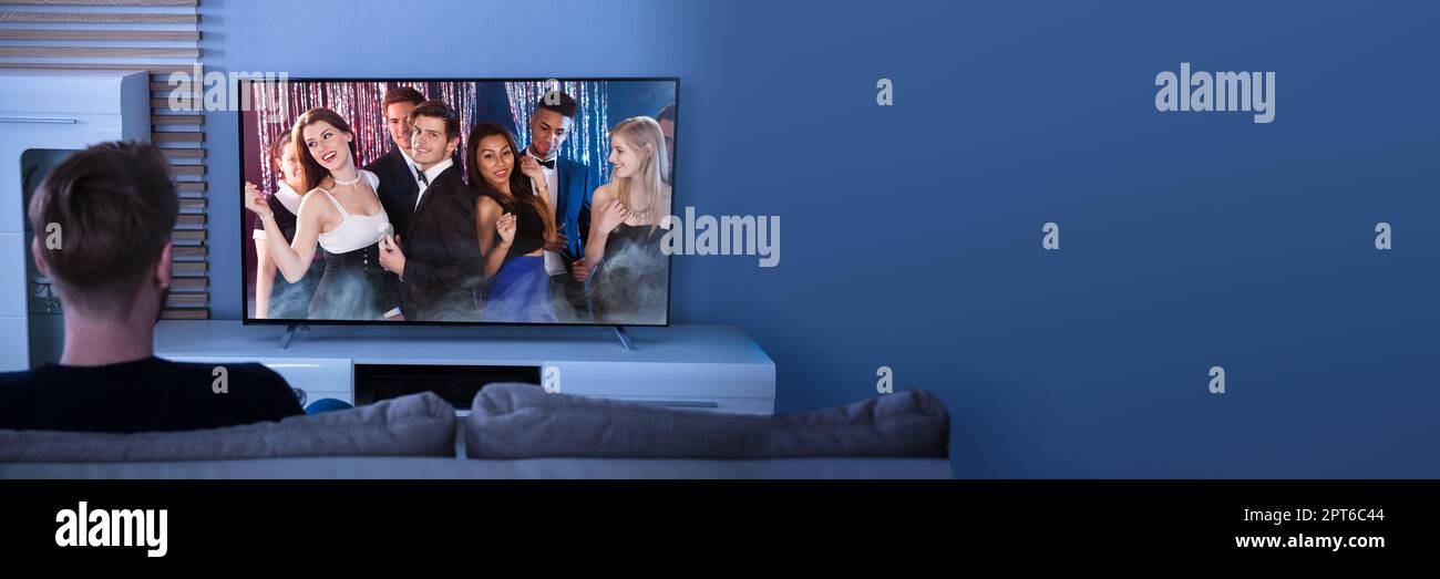 Watching Television On Couch On Living Room. TV Movie Night Stock Photo ...