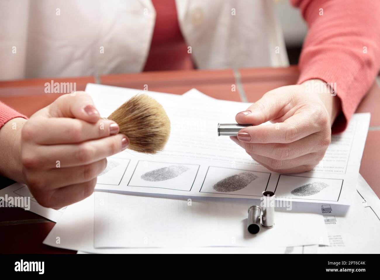 Looking for clues...a forensic scientist at work with a brush and print ...
