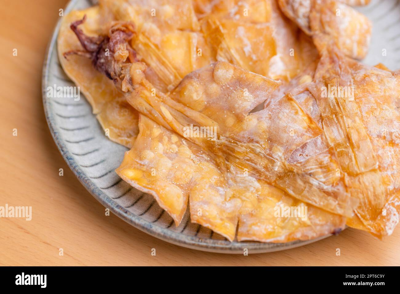 Dried whole squid snack in the plate Stock Photo - Alamy