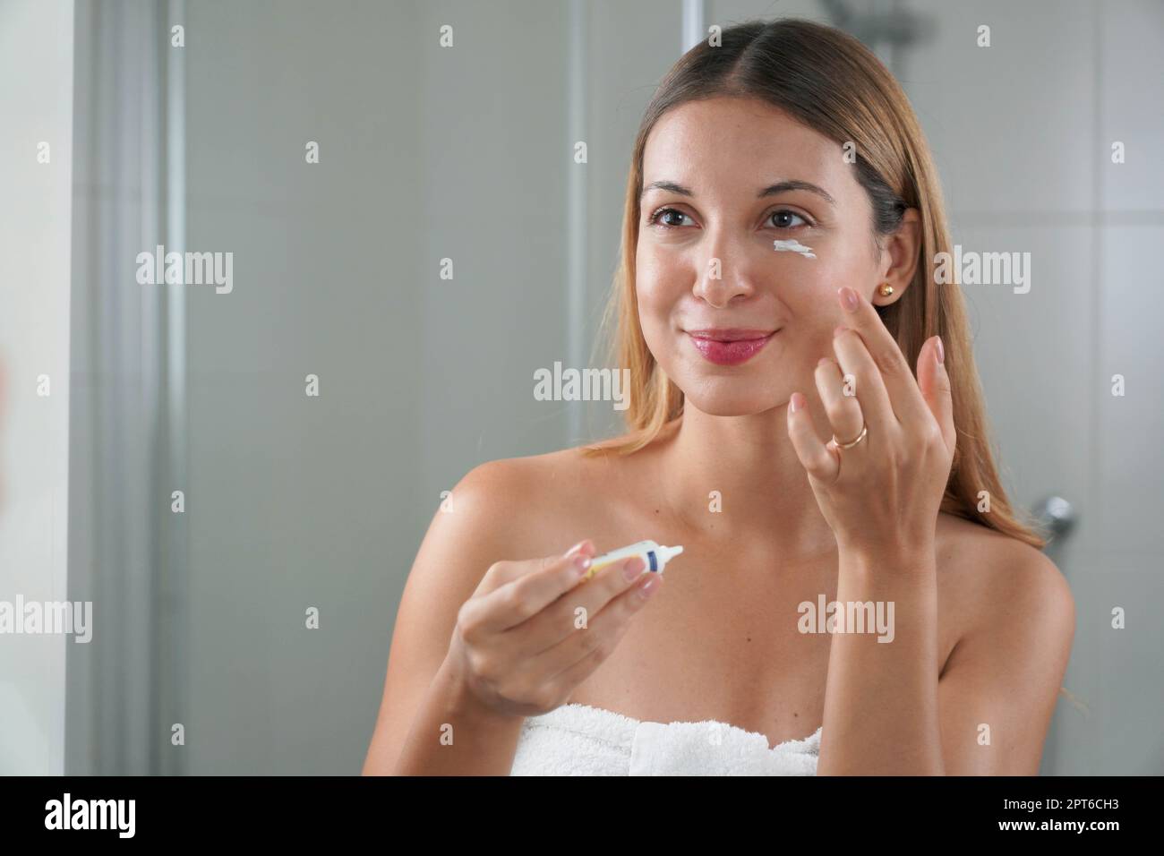 Skin Care Routine Portrait Of Beautiful Girl Applying Cream Under Eye