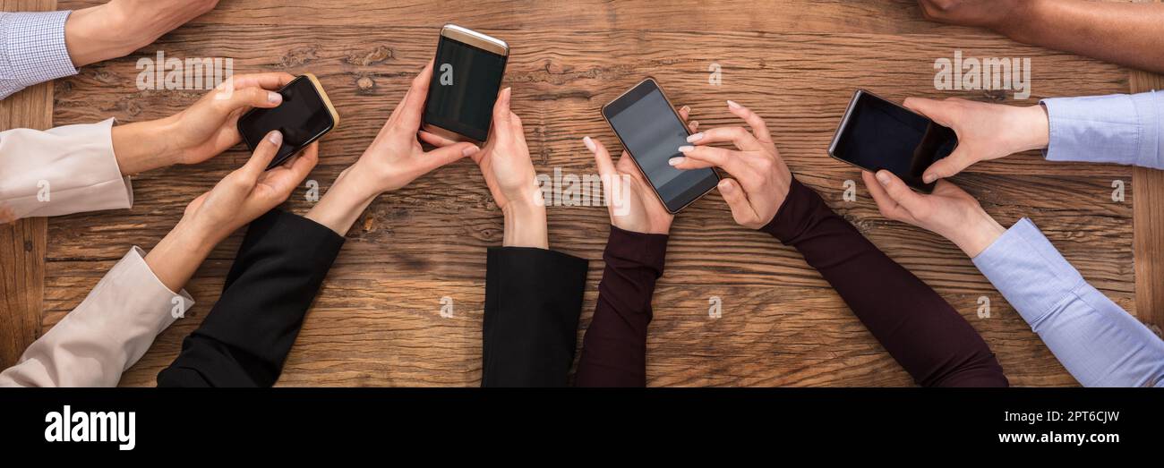 Team Group Using Mobile Phones. Overhead View Stock Photo - Alamy