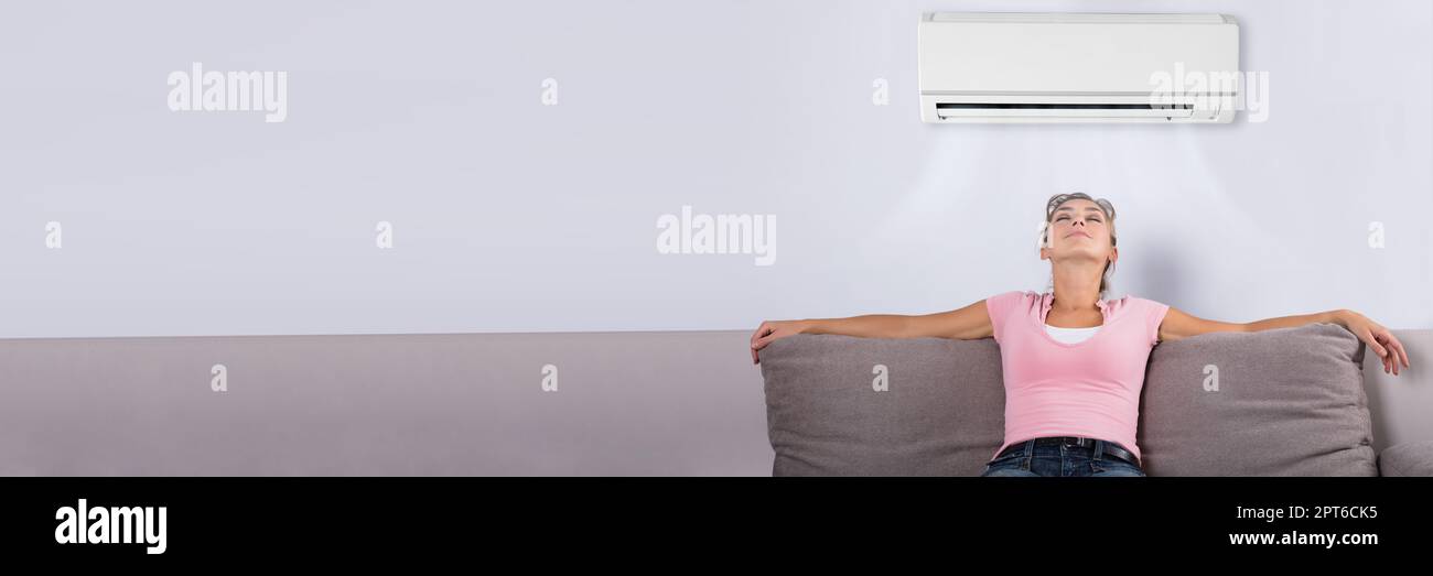 Air Conditioner At Home. Happy Woman Relaxing With AC Stock Photo - Alamy