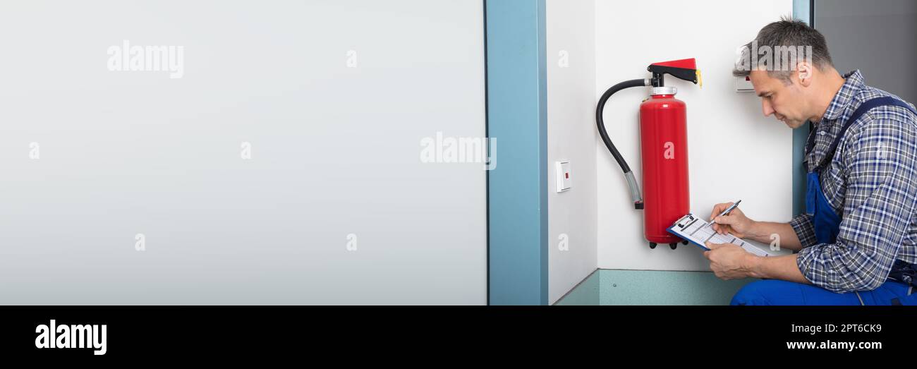 Person Checking Fire Extinguisher. Emergency Evacuation Safety Stock ...