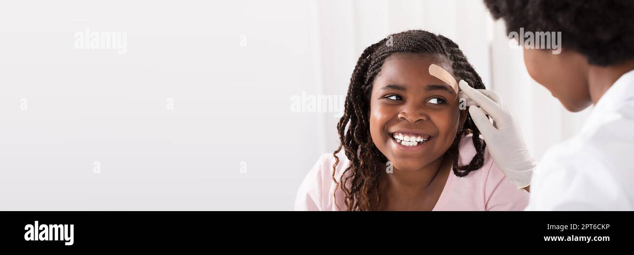Applying Bandage Aid To Wound. African American Doctor Stock Photo - Alamy