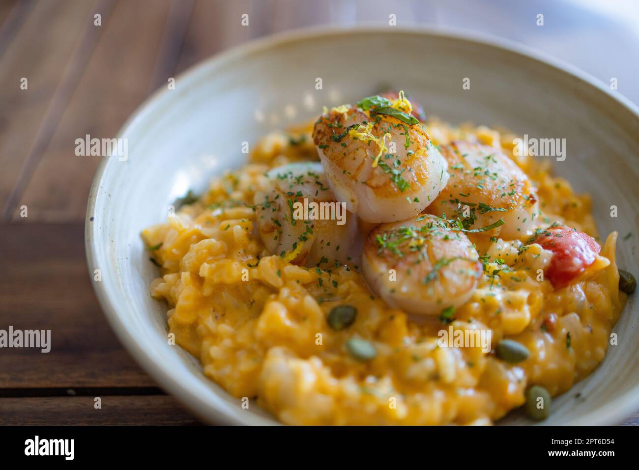 Scallop risotto dish in restaurant Stock Photo - Alamy