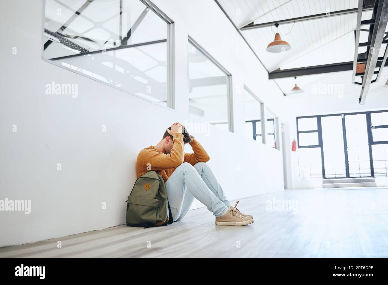 Young man, mental health and stress student, depressed and on floor ...