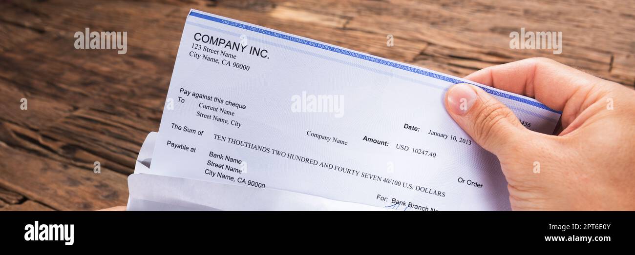 Check Or Paycheck In Hand. Salary Payroll Stock Photo - Alamy