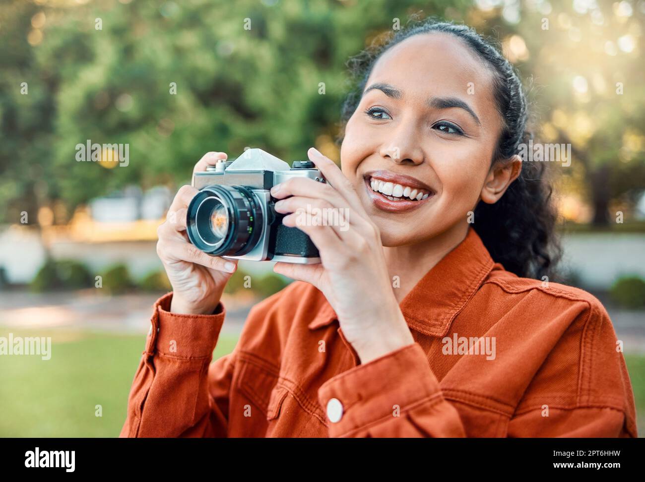 Creative juices flowing. a young woman holding her camera while ...
