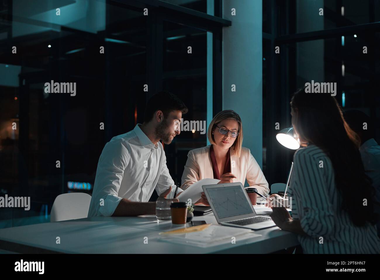 Teamwork will get them through the night. colleagues having a meeting ...