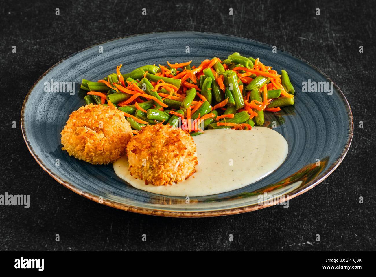 Meatballs in breading served with green bean and spicy carrot Stock ...