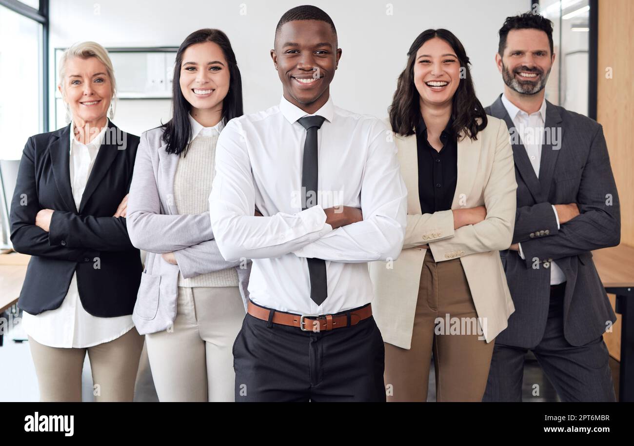 Let us take on the job. a group of businesspeople standing in an office ...