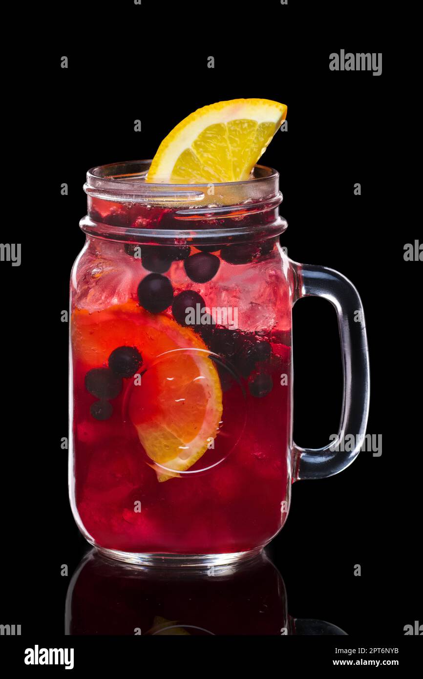 Cocktail with black currant and vodka in mason jar mug isolated on ...