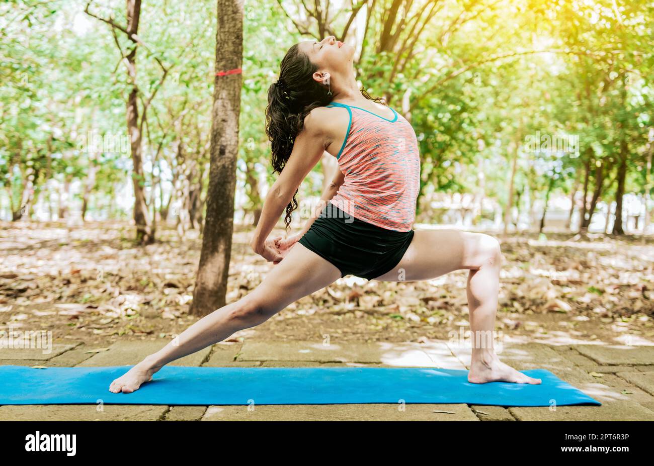 Young woman doing yoga Anjaneyasana or Crescent Moon Pose. Girl ...