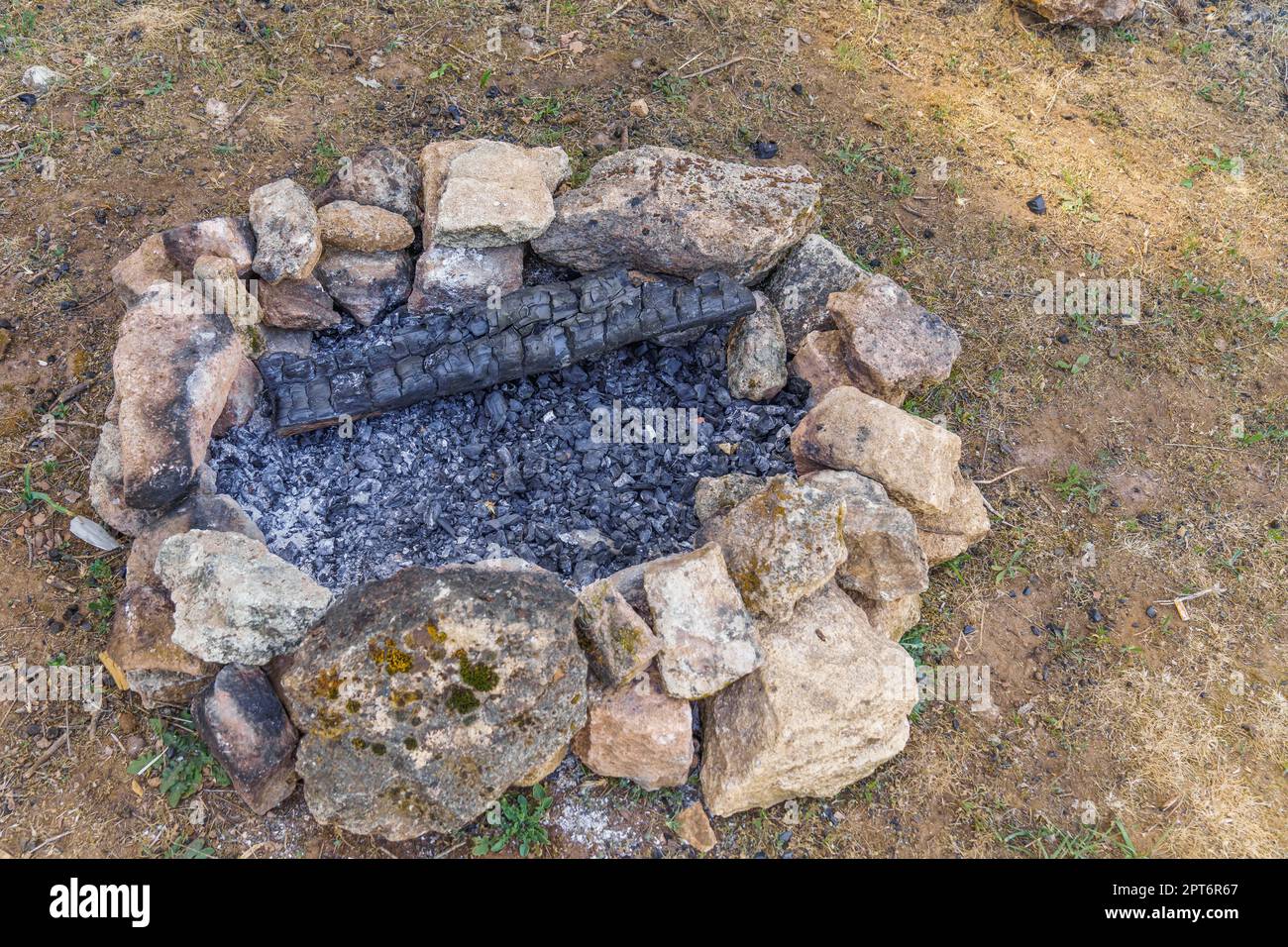 Fire extinguished in the field with stones around it, concept cause of ...