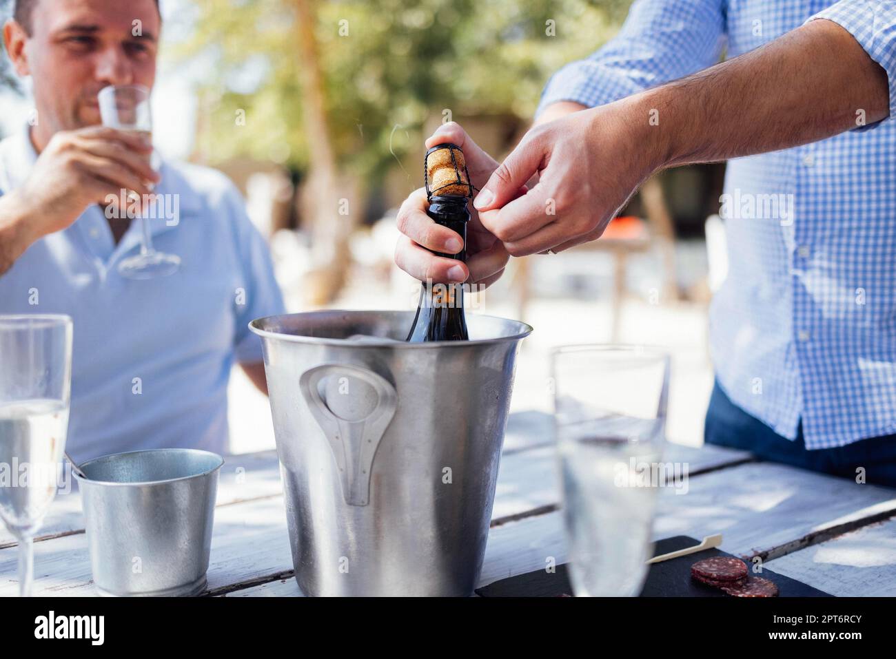 Happy people on the beach having a party, drinking and having a lot of ...