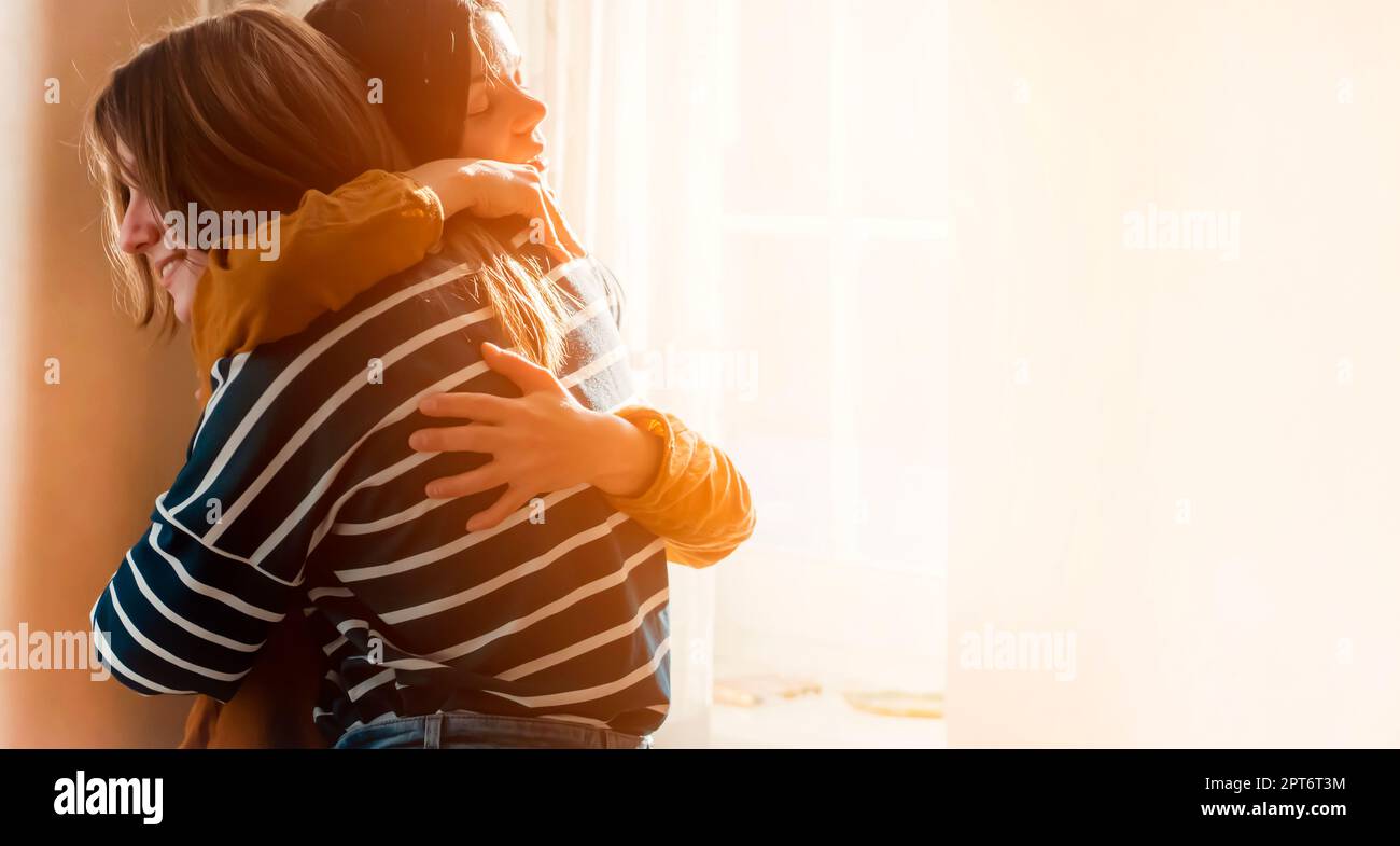 Two girls hug and congratulate each other Stock Photo - Alamy